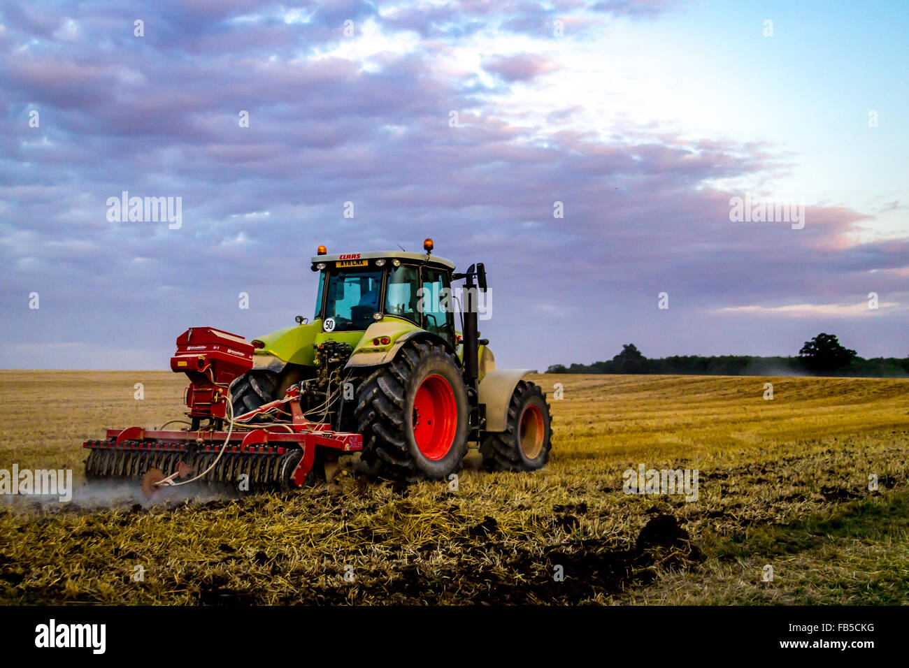 Case tractor and seed drill drilling land on an arable farm Stock Photo ...