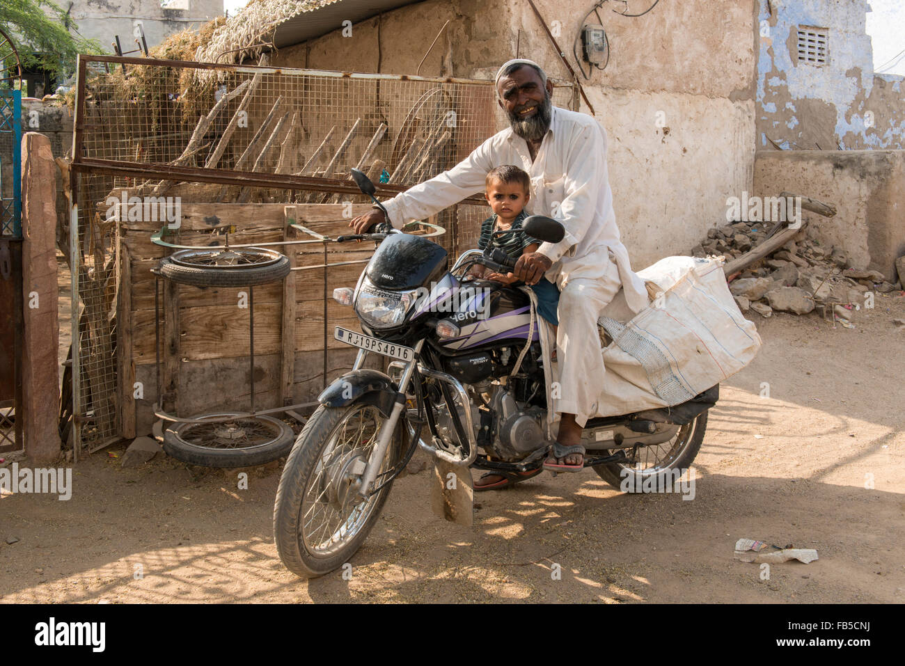 Muslim Man On Motorcycle With Baby Girl Stock Photo - Alamy