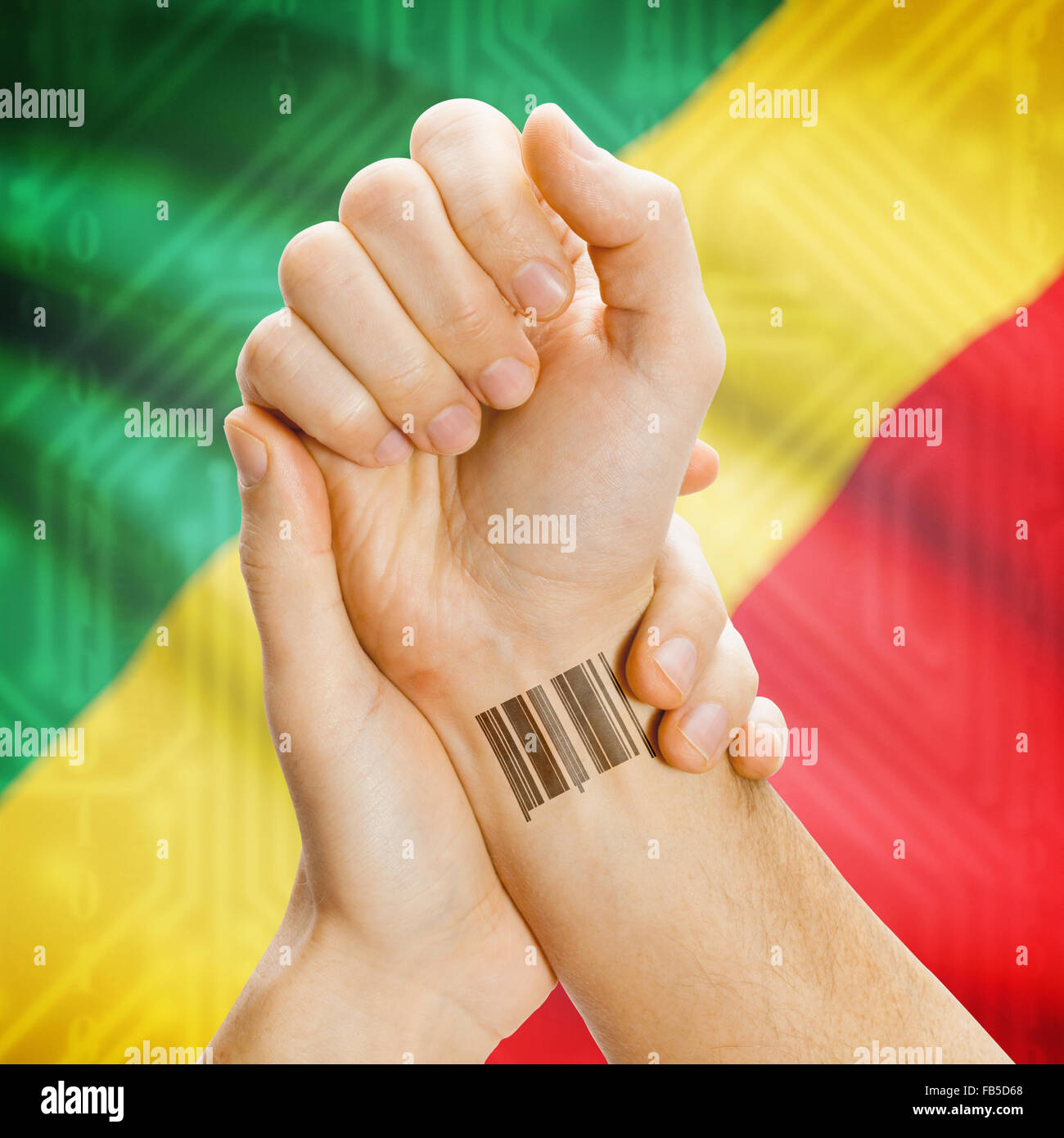Barcode ID number on wrist of a human and national flag on background ...