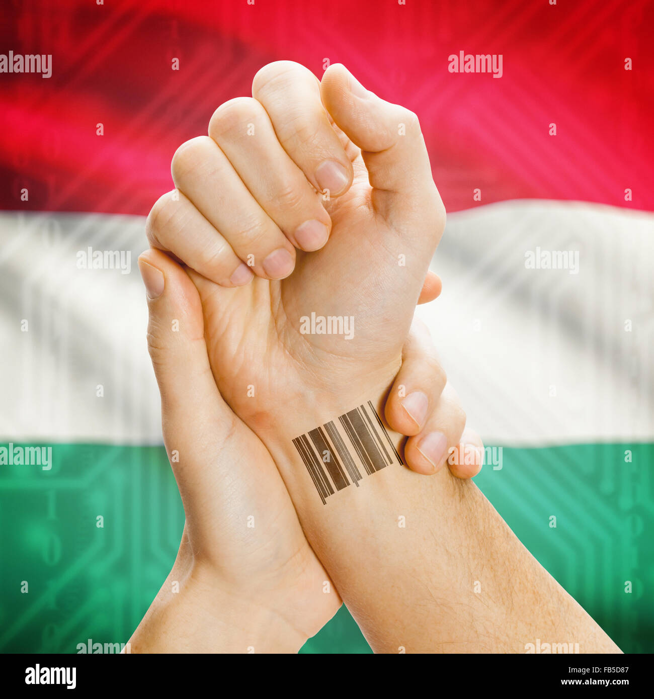 Barcode ID number on wrist of a human and national flag on background ...