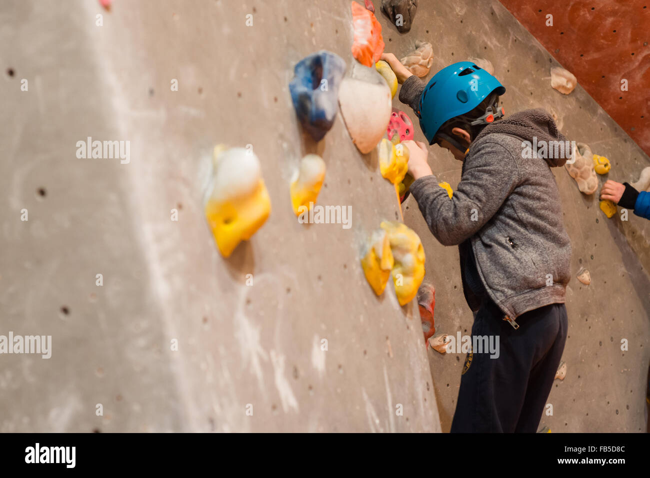 boy climbing without ropes at Edinburgh International climbing Arena ...