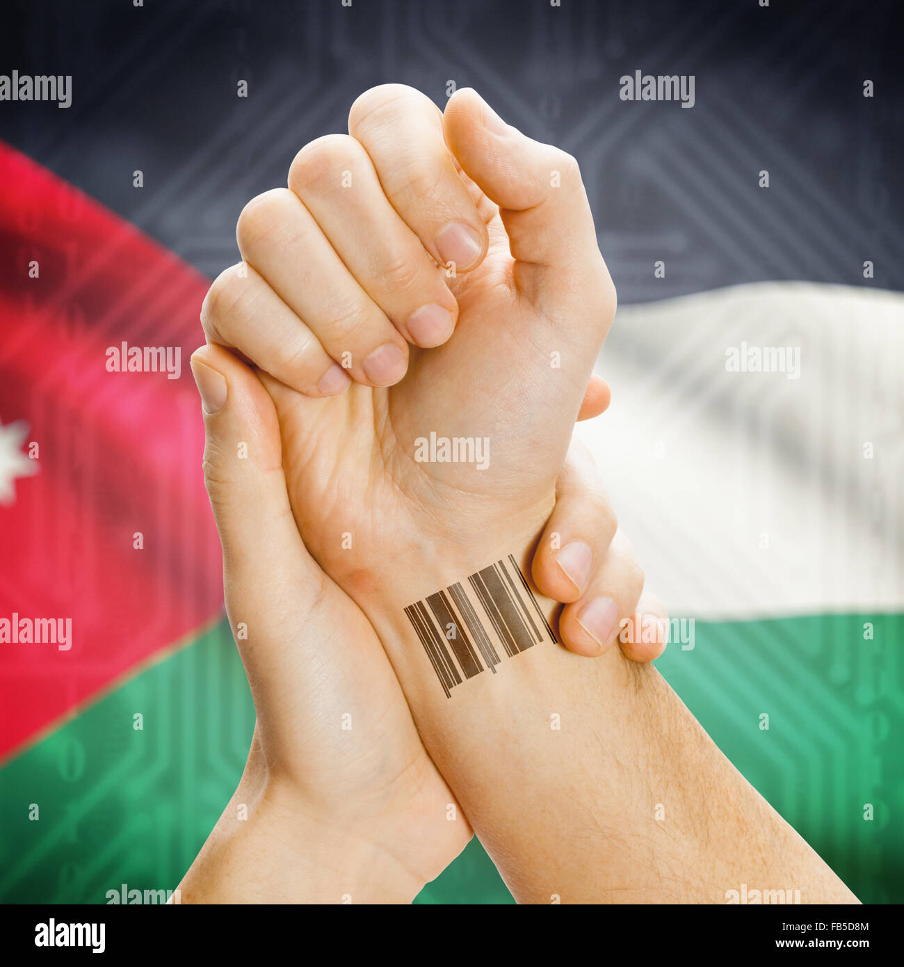 Barcode ID number on wrist of a human and national flag on background ...