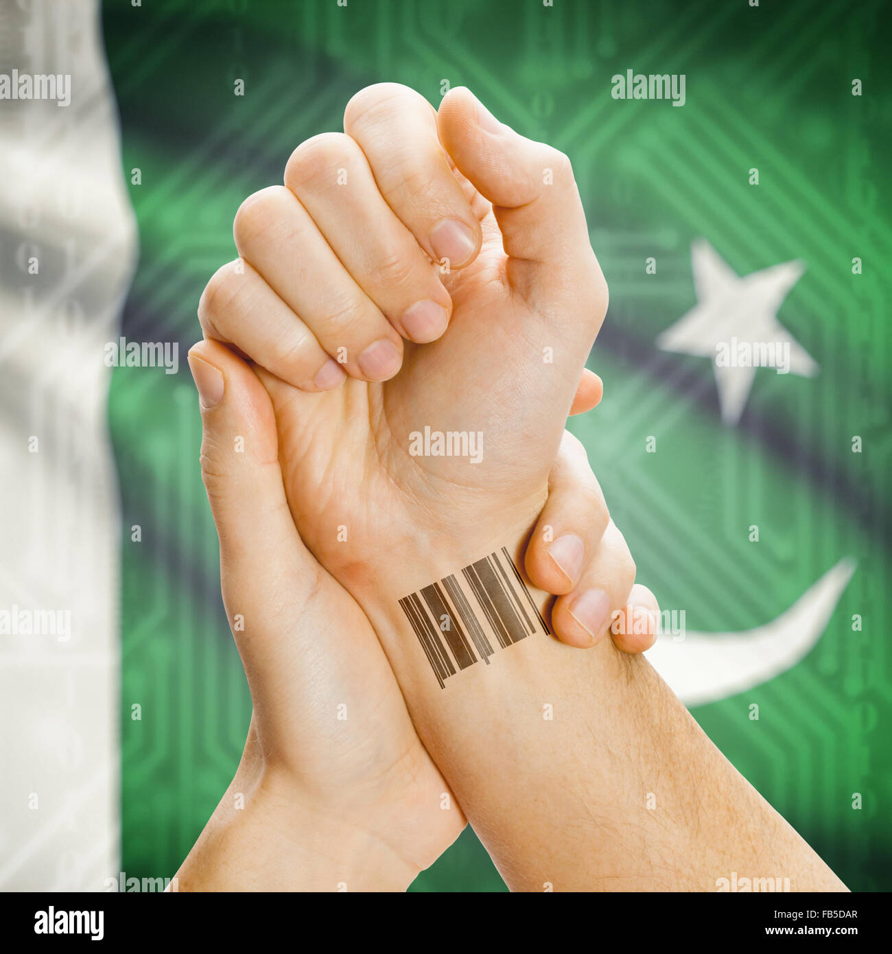Barcode ID number on wrist of a human and national flag on background ...