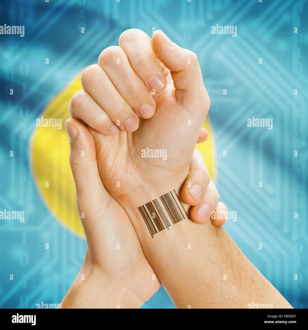 Barcode ID number on wrist of a human and national flag on background ...