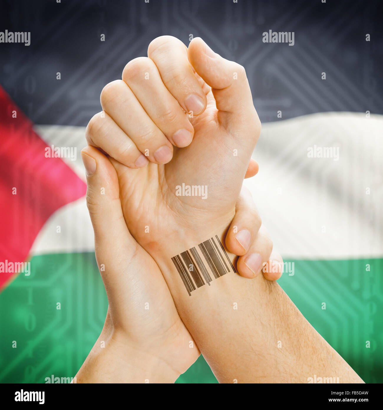 Barcode ID number on wrist of a human and national flag on background ...