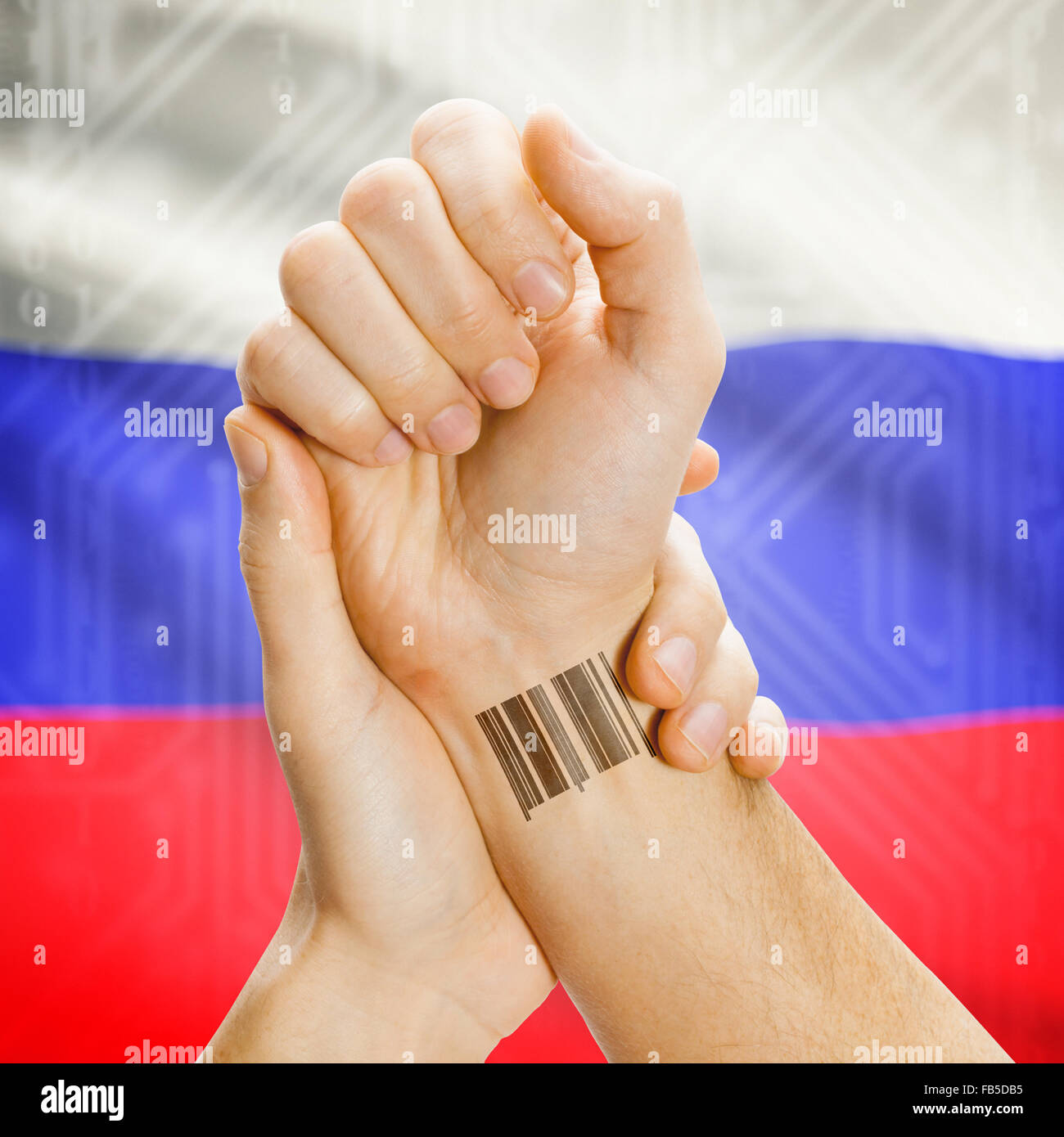 Barcode ID number on wrist of a human and national flag on background ...