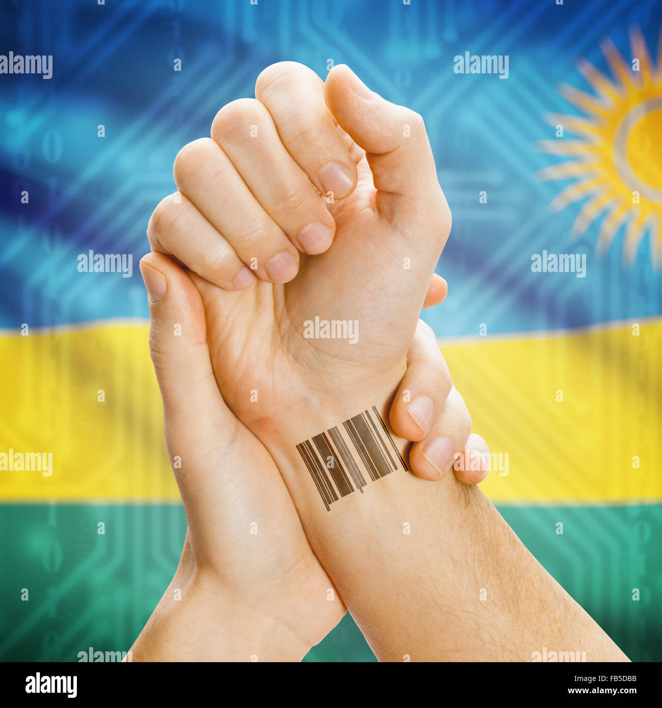 Barcode ID number on wrist of a human and national flag on background ...