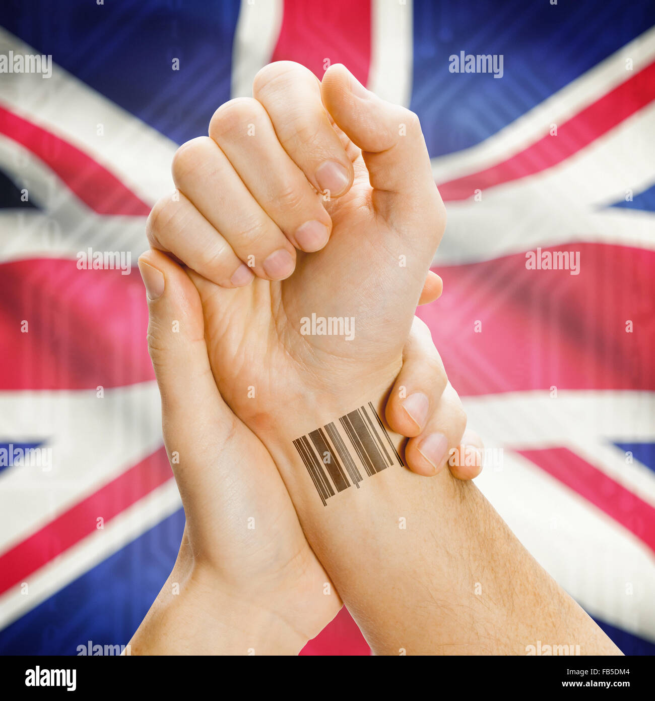 Barcode ID number on wrist of a human and national flag on background ...
