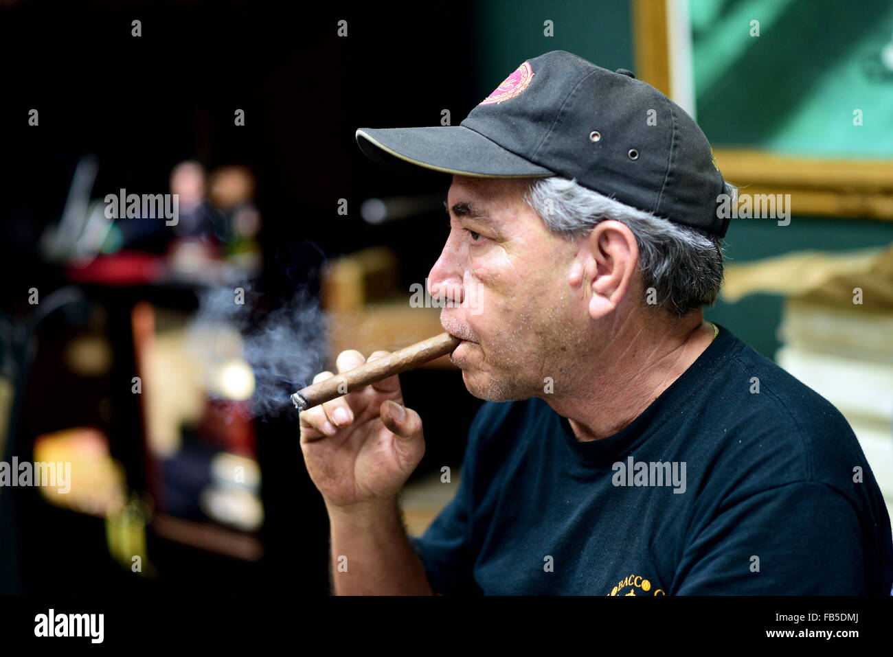A Cigar Roller Smoking A Cigar In Little Havana, Miami, Florida Stock ...