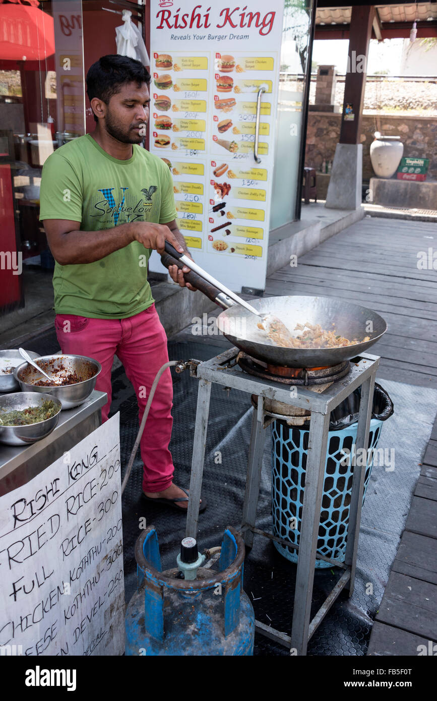 A cook frying rice at one of the small eateries at the Pettah floating ...
