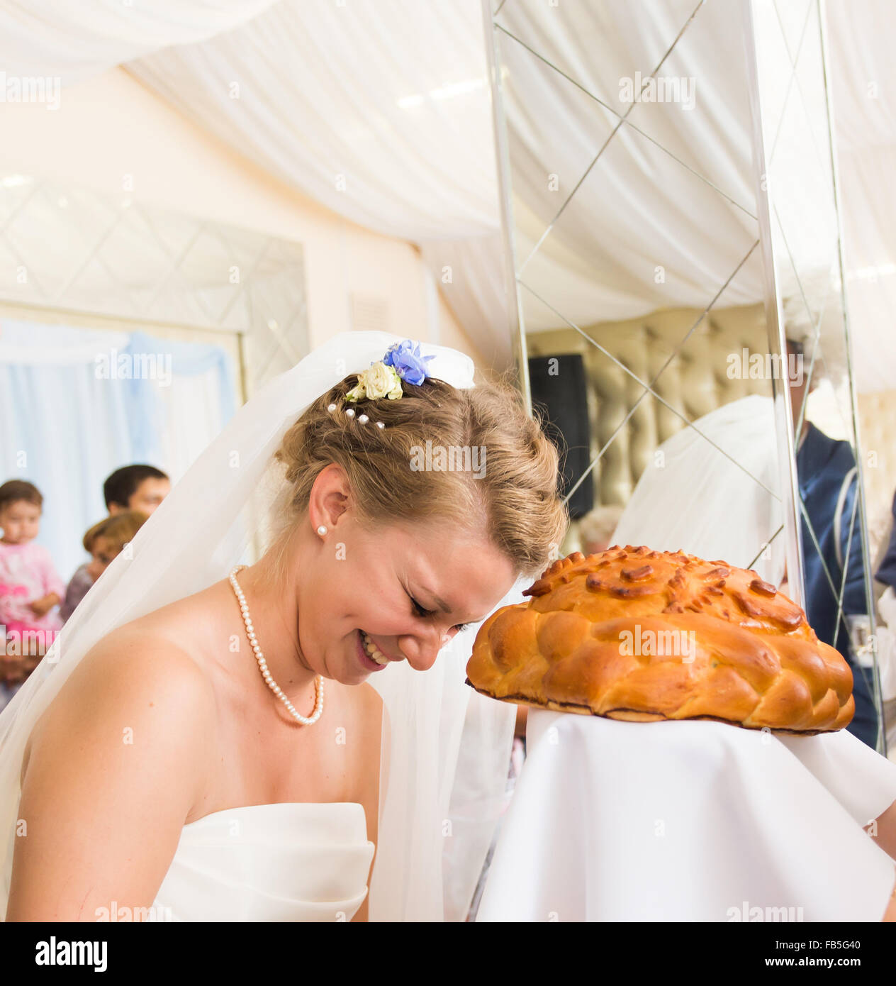 traditional wedding custom to bite a large piece of bread Stock Photo ...
