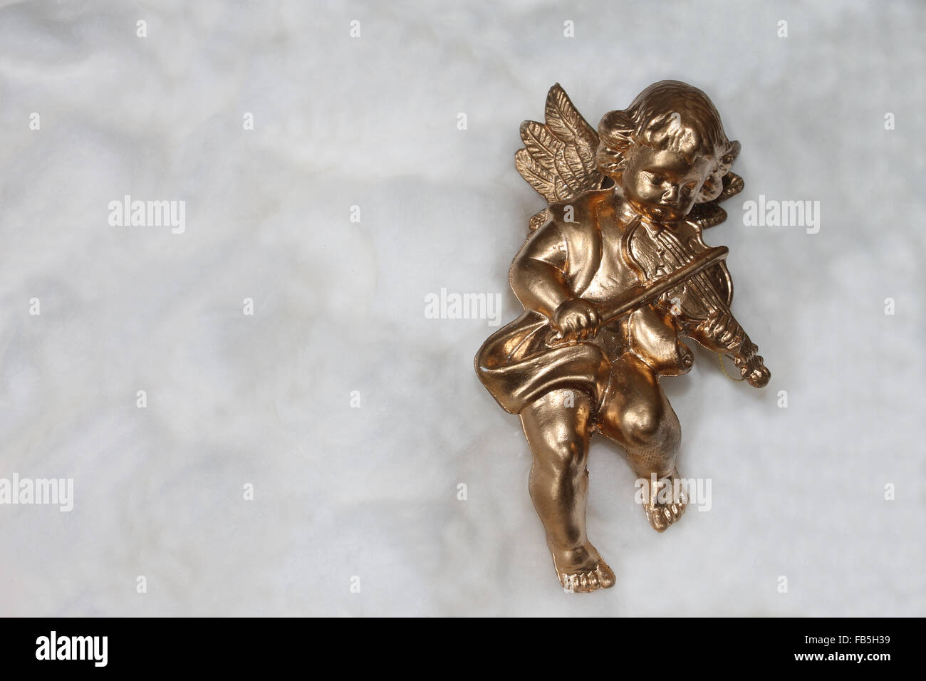 Cherub figure playing violin on a cotton wool cloud effect background ...