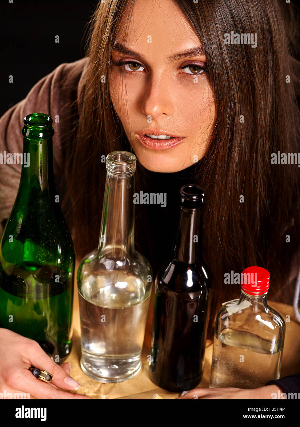 Drunk girl holding bottle of vodka Stock Photo - Alamy