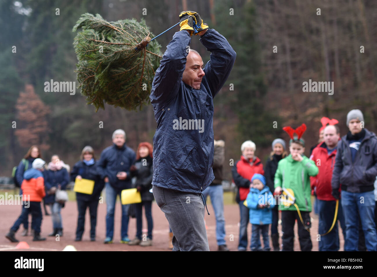 A participant hurls a fir tree during the 10th Christmas-tree-throwing ...