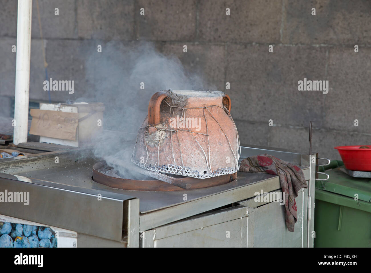 Traditional clay pot smoking on a stall in Madeira Stock Photo - Alamy