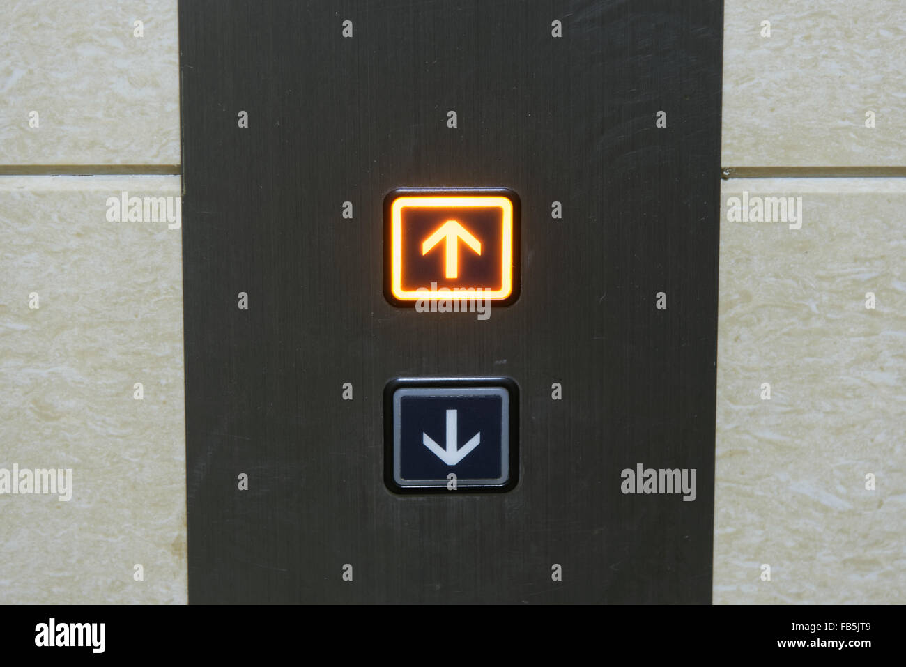 Up and down elevator buttons with up-button lighten up Stock Photo - Alamy