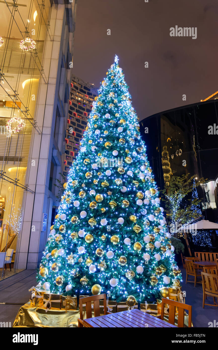 big public christmas tree with blue lights on the street with ...