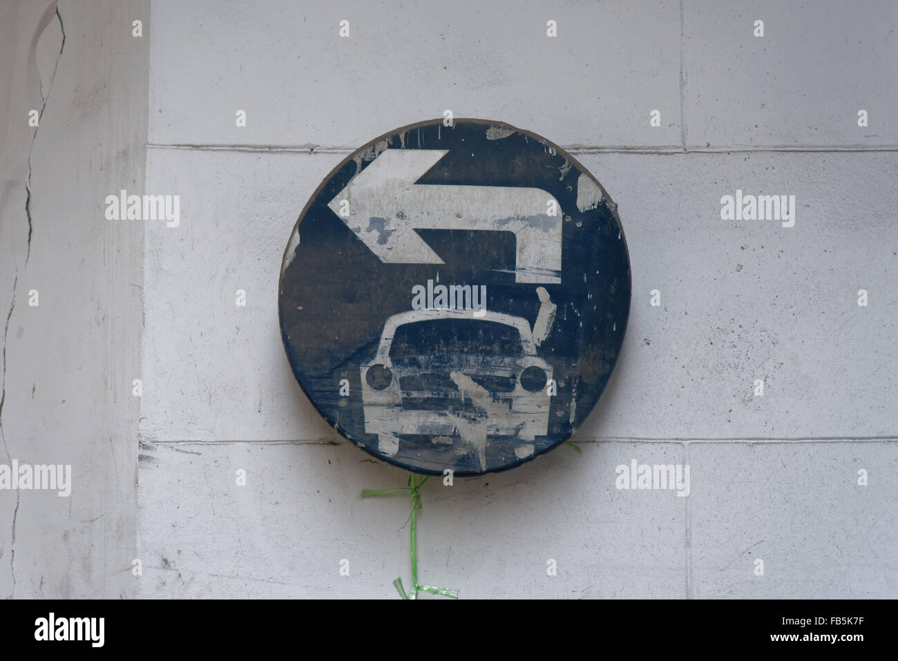 Old blue left turn car sign on a white wall Stock Photo - Alamy