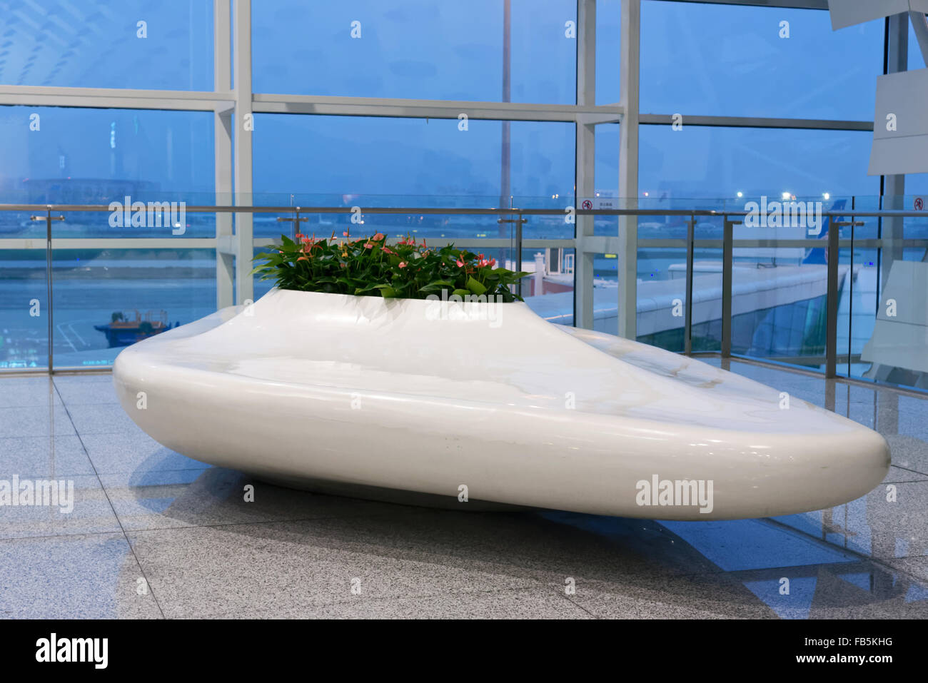 Futuristic design public white bench at an airport Stock Photo - Alamy