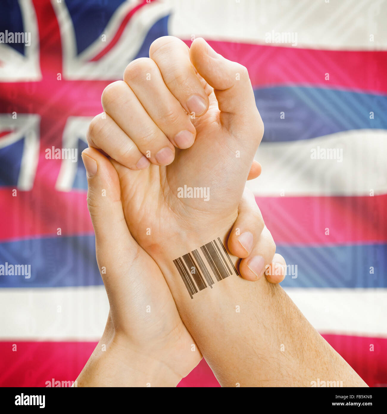 Barcode ID number tatoo on wrist and USA statesl flag on background ...