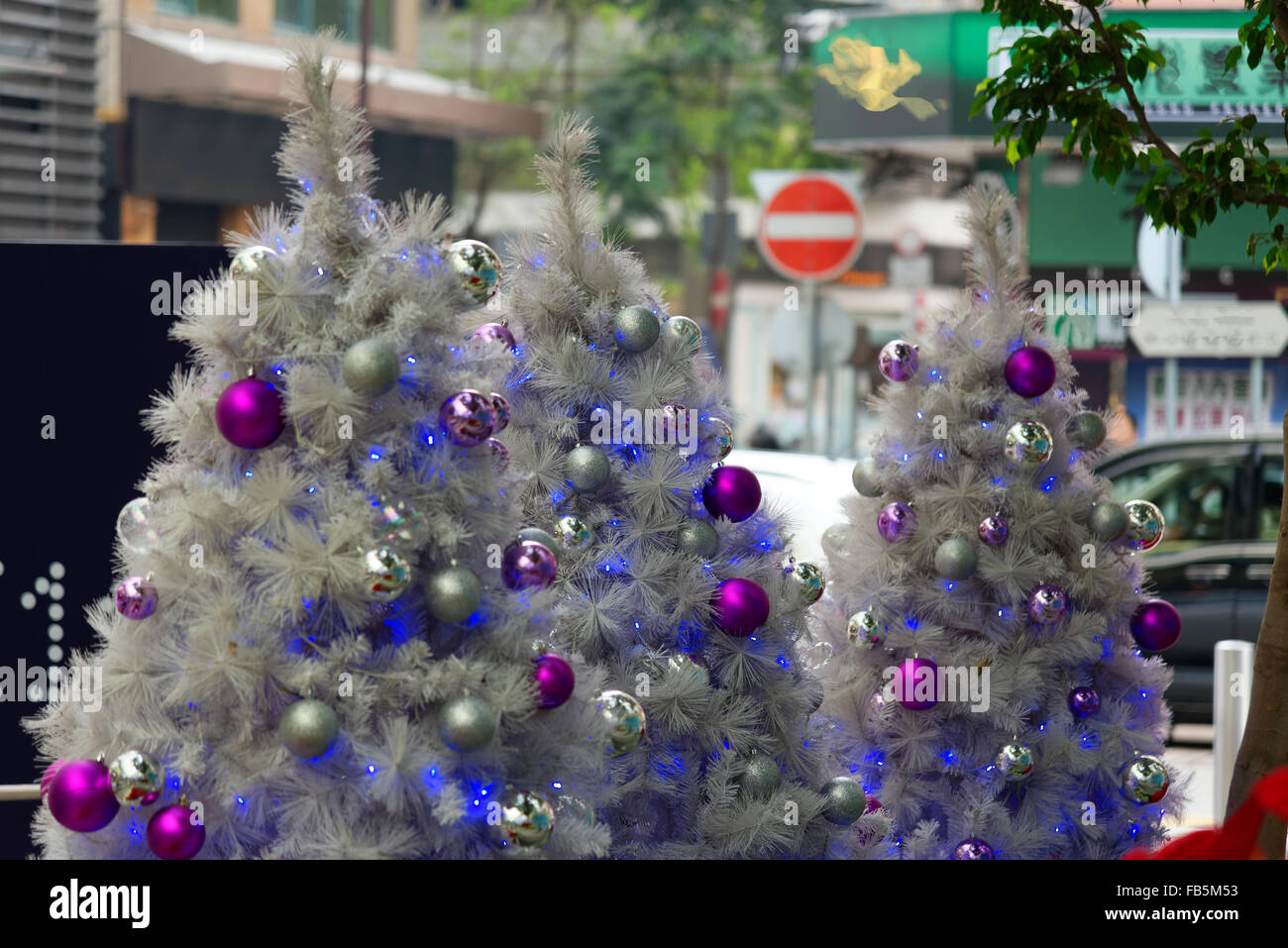 three white christmas trees and a stop sign in the background Stock ...