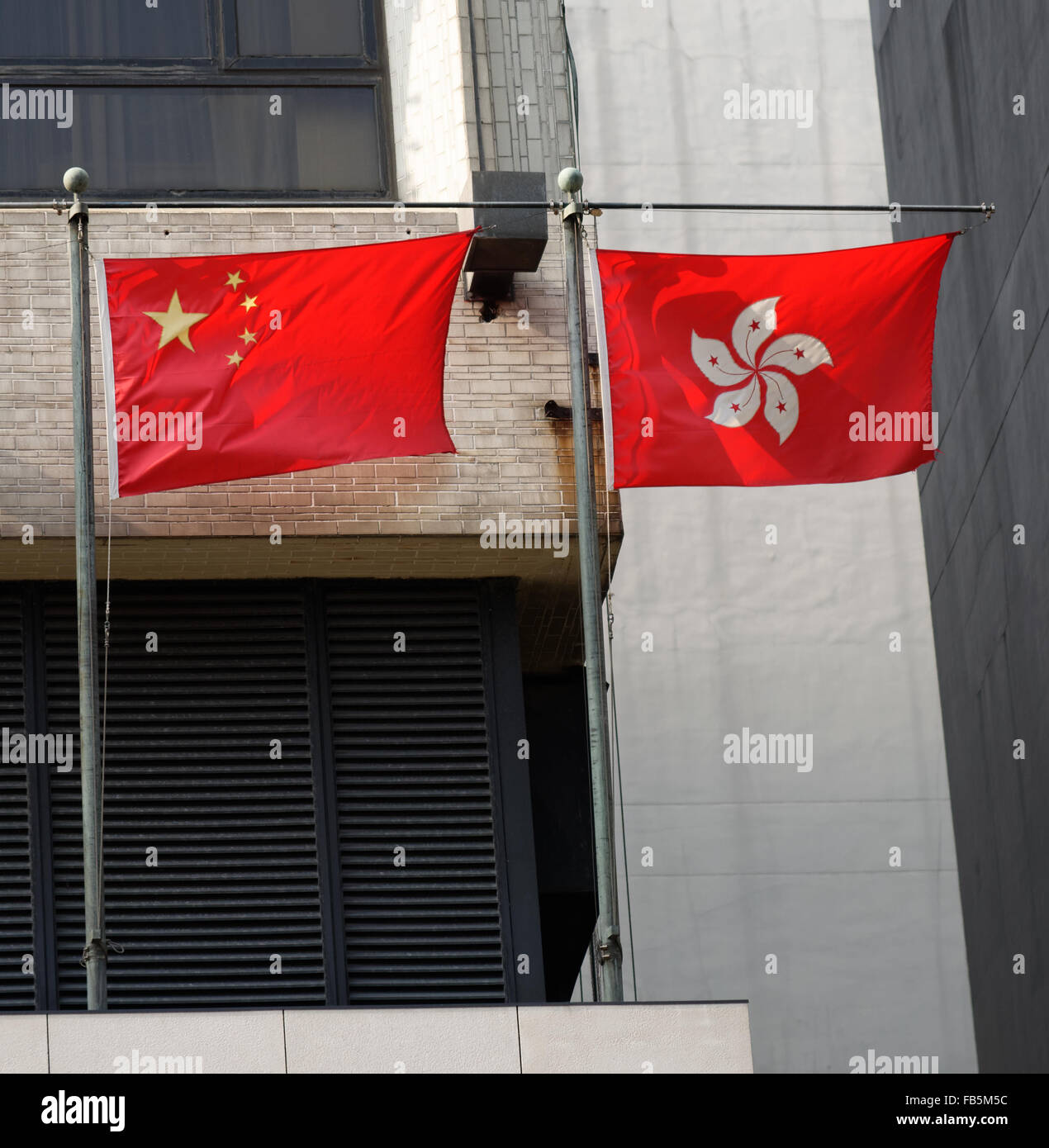 Chinese and hong kong flags hanging side by side on two poles Stock ...