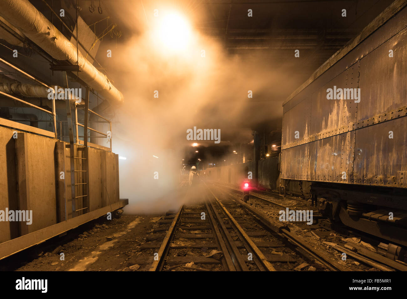 Worker traversing the underground train tracks of Grand Central Station ...