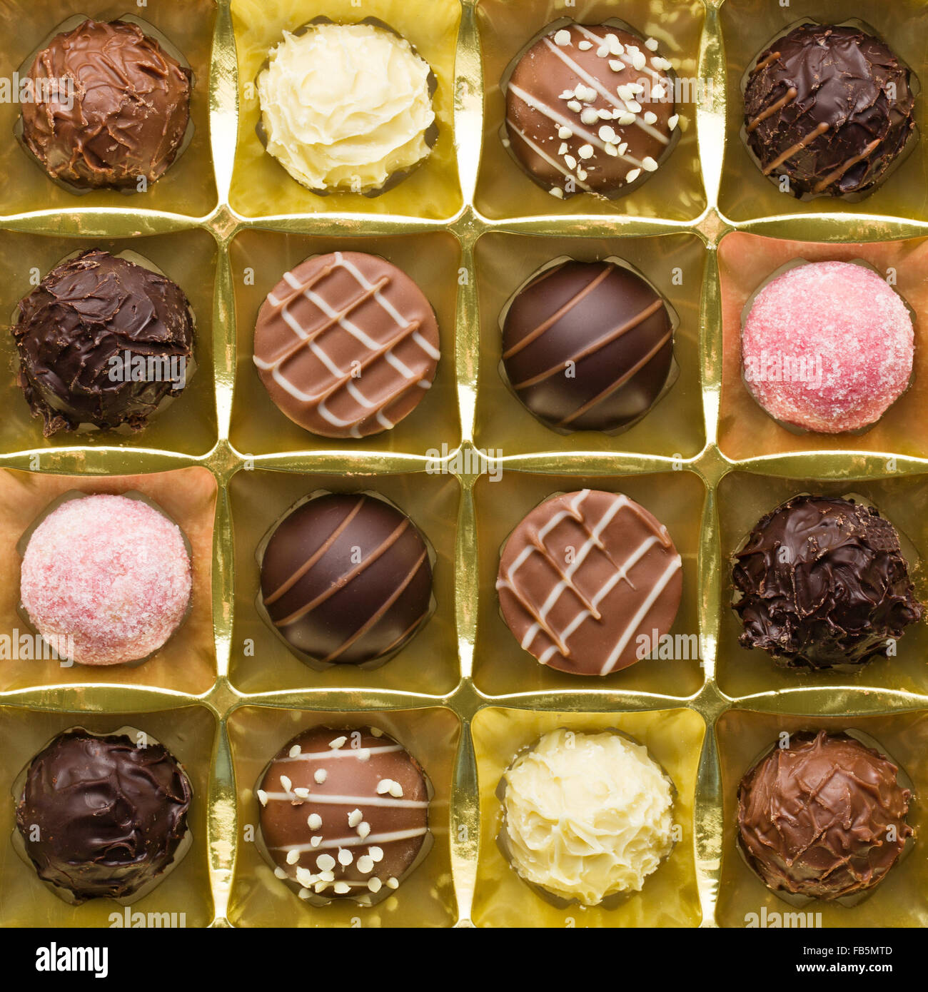 various chocolate pralines in golden box Stock Photo - Alamy