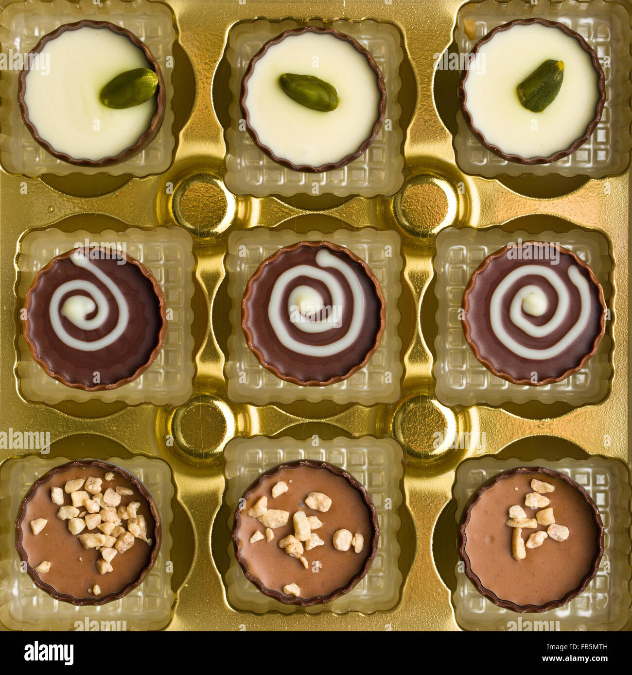 various chocolate pralines in golden box Stock Photo - Alamy