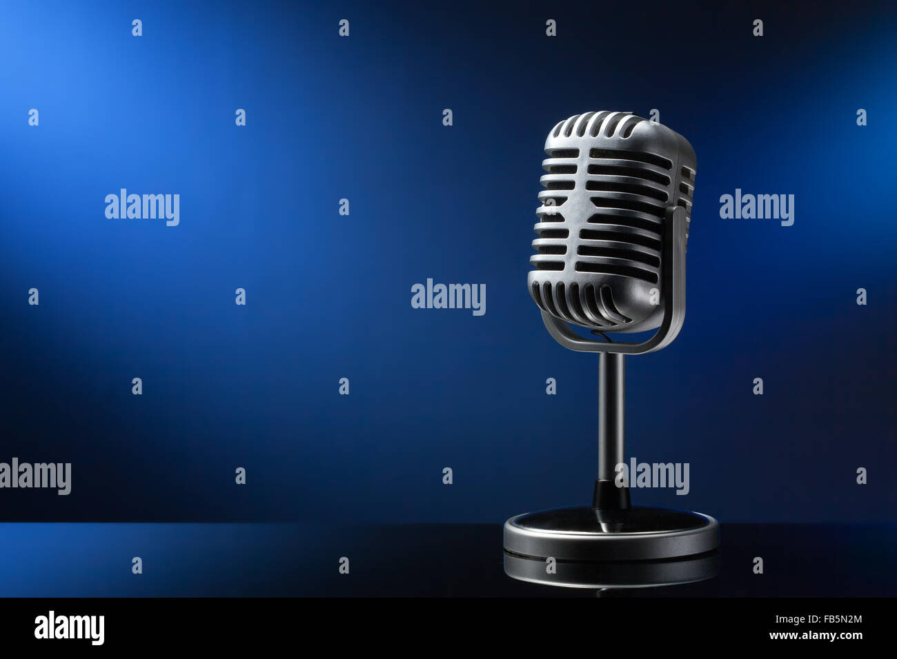 Retro microphone on blue background Stock Photo - Alamy