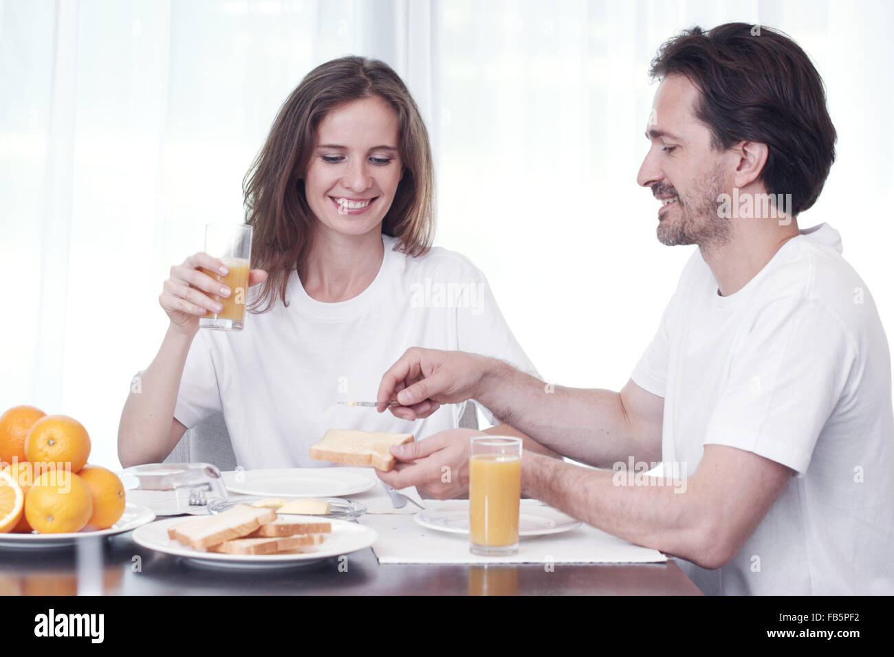 Couple having breakfast together at home Stock Photo - Alamy