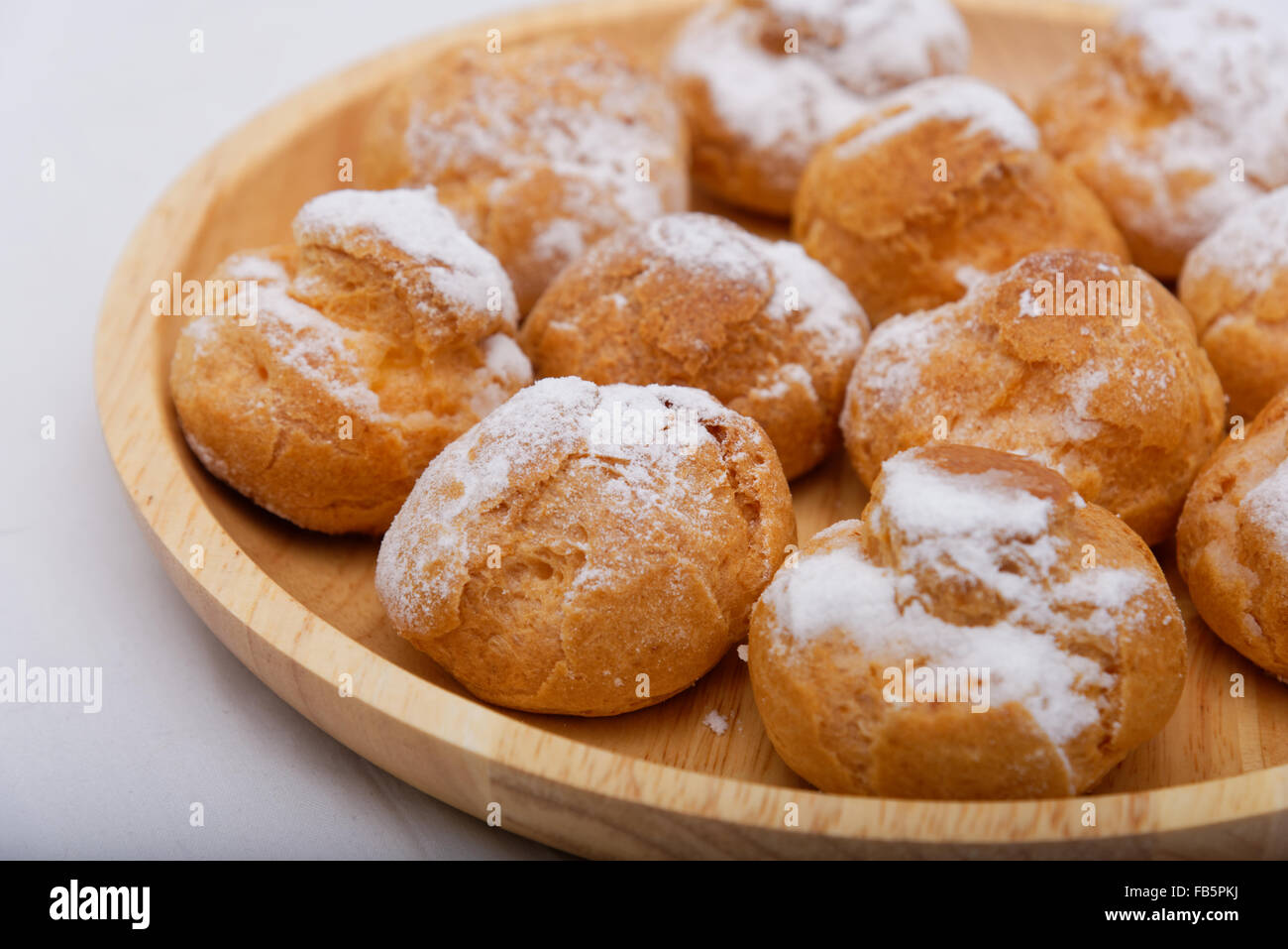 closeup of bakery products with sugar powder on a wooden plate Stock ...