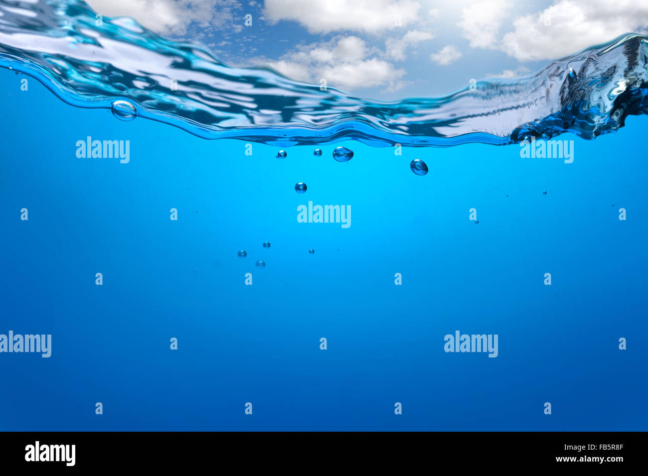Splash of blue water with bubbles and blue sky. Underwater image Stock ...