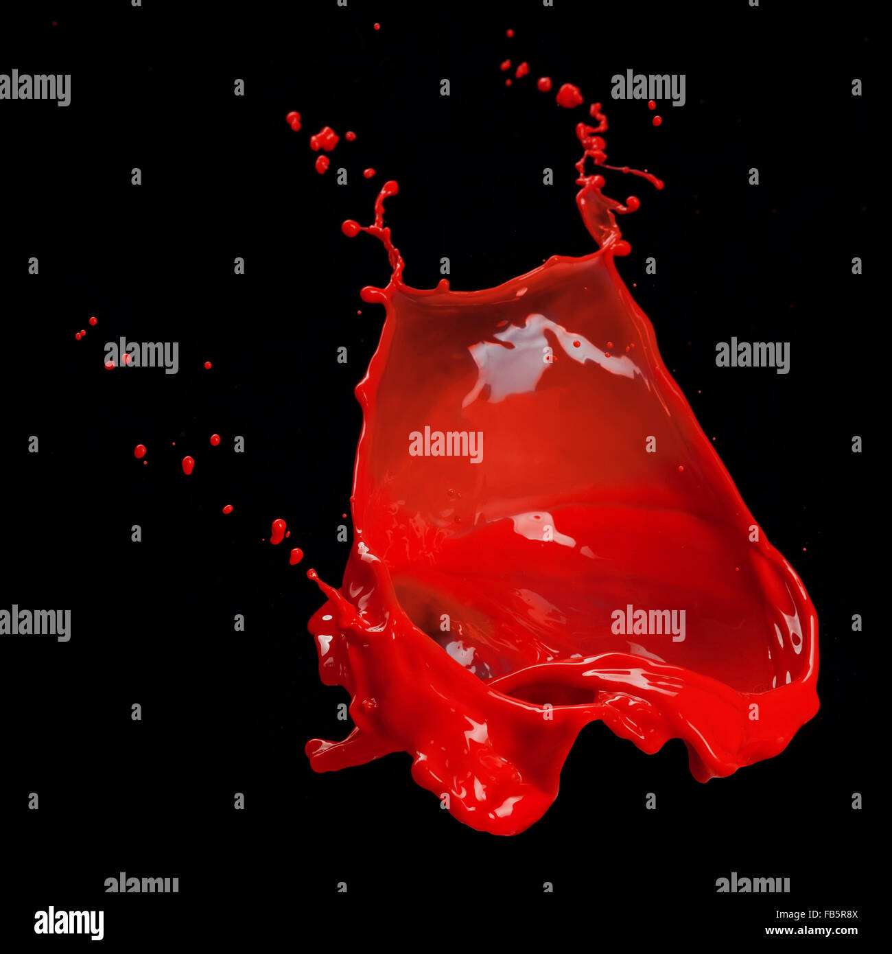 splash of red paint isolated on black background Stock Photo - Alamy