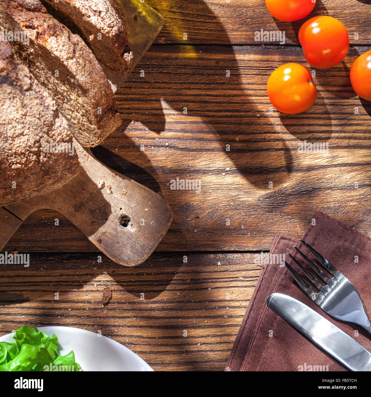 Top view of italian food on wooden table - bread, olive oil and tomatos ...