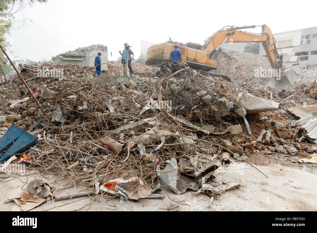 Building demolition site with excavator and workers Stock Photo - Alamy