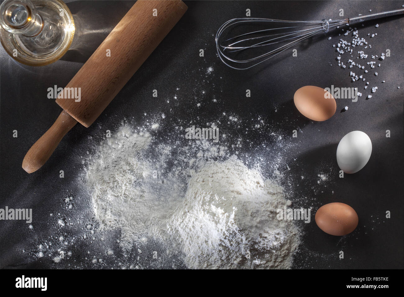 flour and ingredients on black table. Top view Stock Photo - Alamy