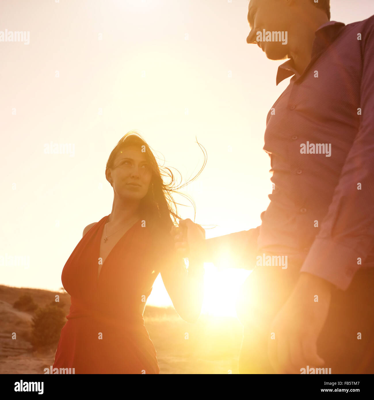 Woman and man holding hands on sunrise Stock Photo - Alamy