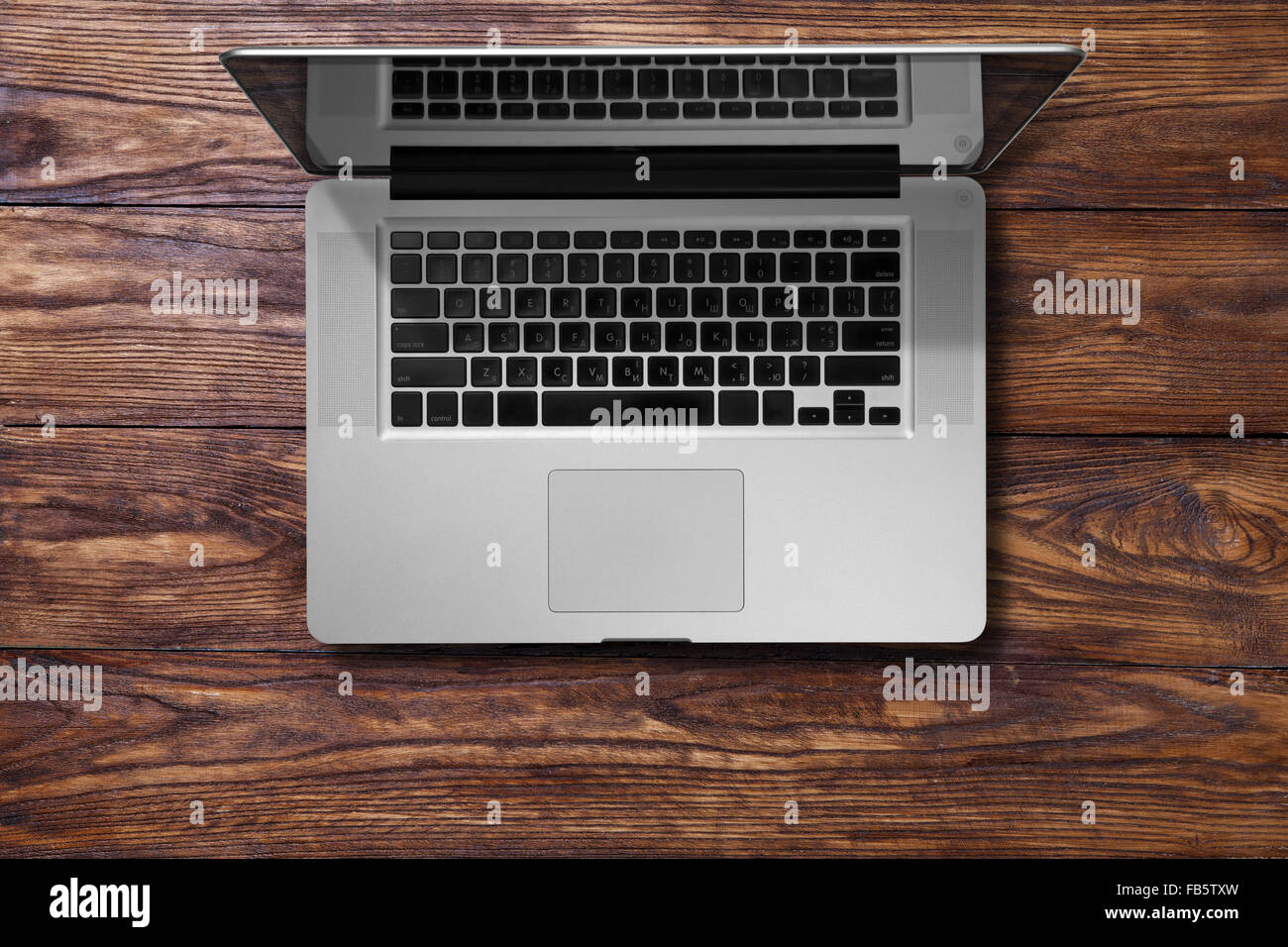 Open laptop on brown wooden table. Top view Stock Photo - Alamy