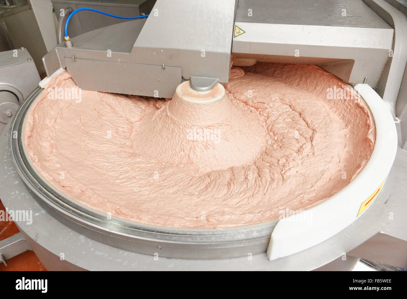 minced meat in a factory meat grinder Stock Photo - Alamy