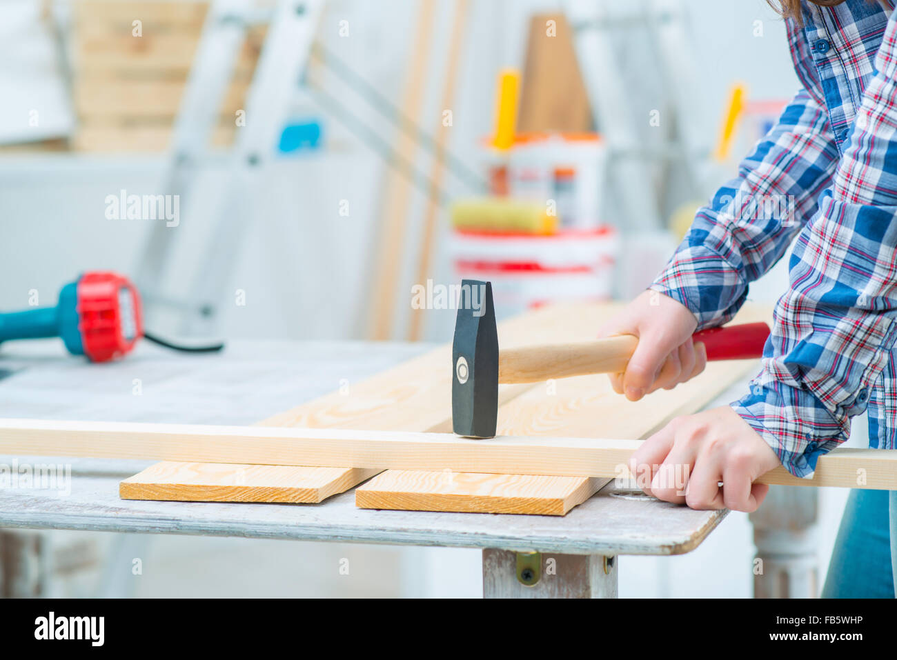 Happy woman using hammer Stock Photo - Alamy