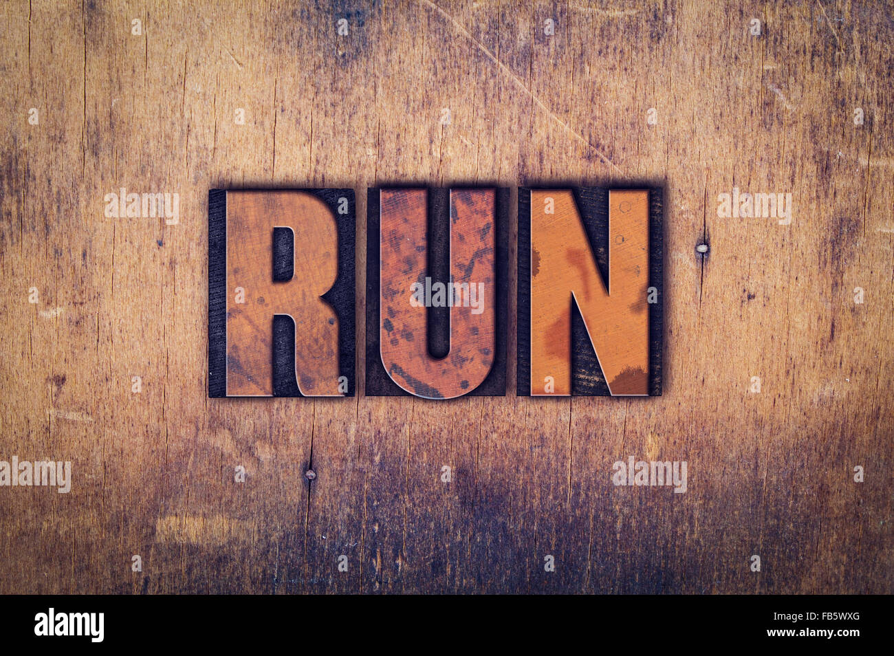 The word "Run" written in dirty vintage letterpress type on a aged ...