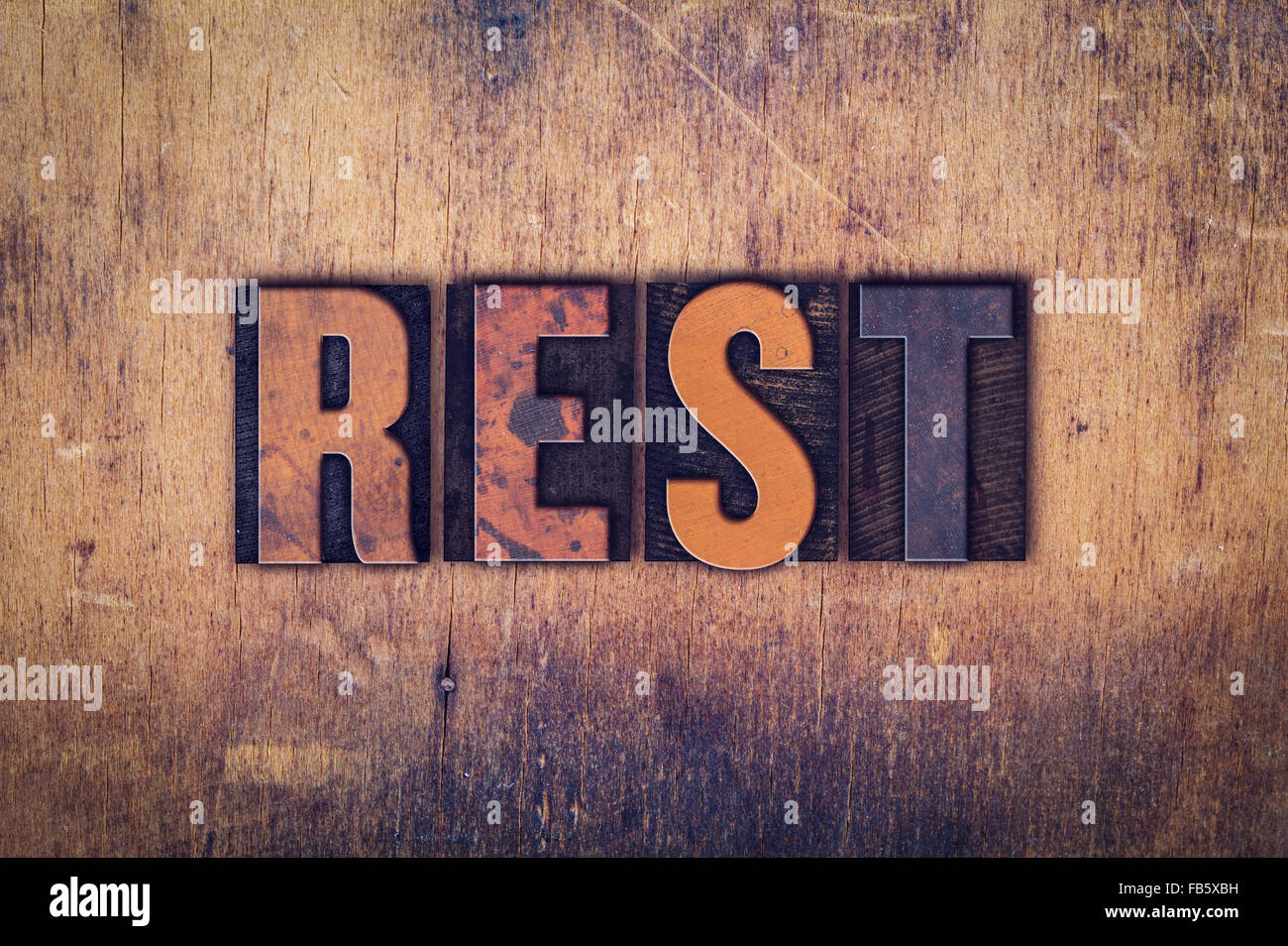 The word "Rest" written in dirty vintage letterpress type on a aged ...