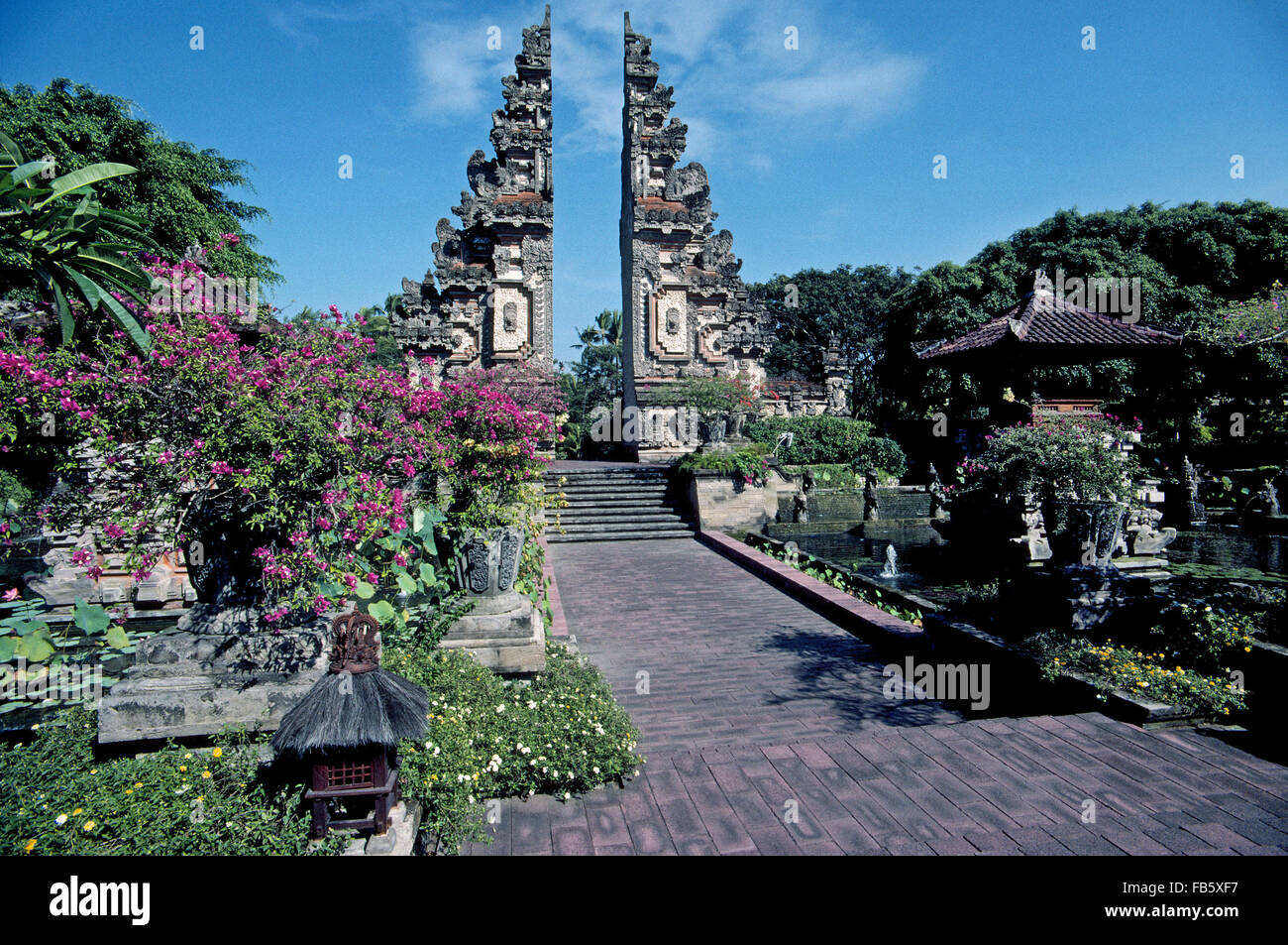 An elaborate hand-carved Balinese split gate called candi bentar leads ...