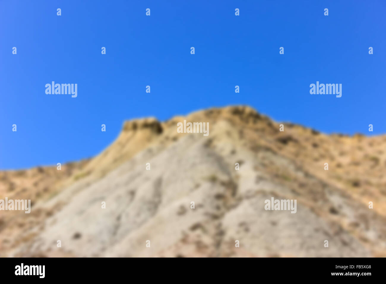 Blurred sand hill under clear blue sky Stock Photo - Alamy