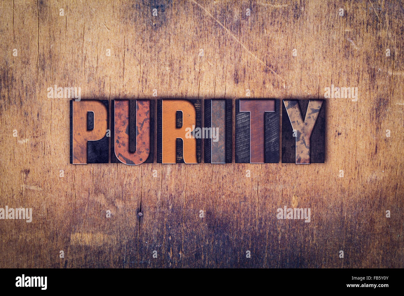 The word "Purity" written in dirty vintage letterpress type on a aged ...
