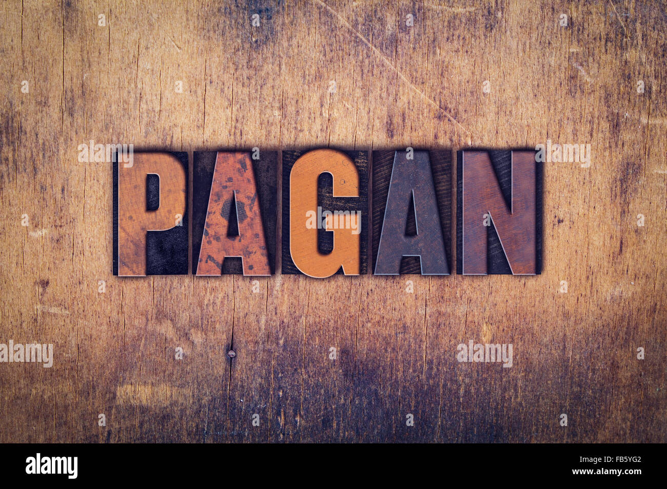 The word "Pagan" written in dirty vintage letterpress type on a aged ...