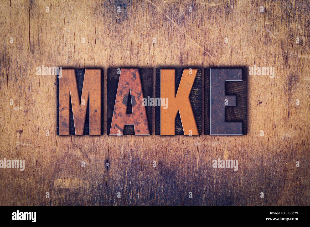 The word "Make" written in dirty vintage letterpress type on a aged ...