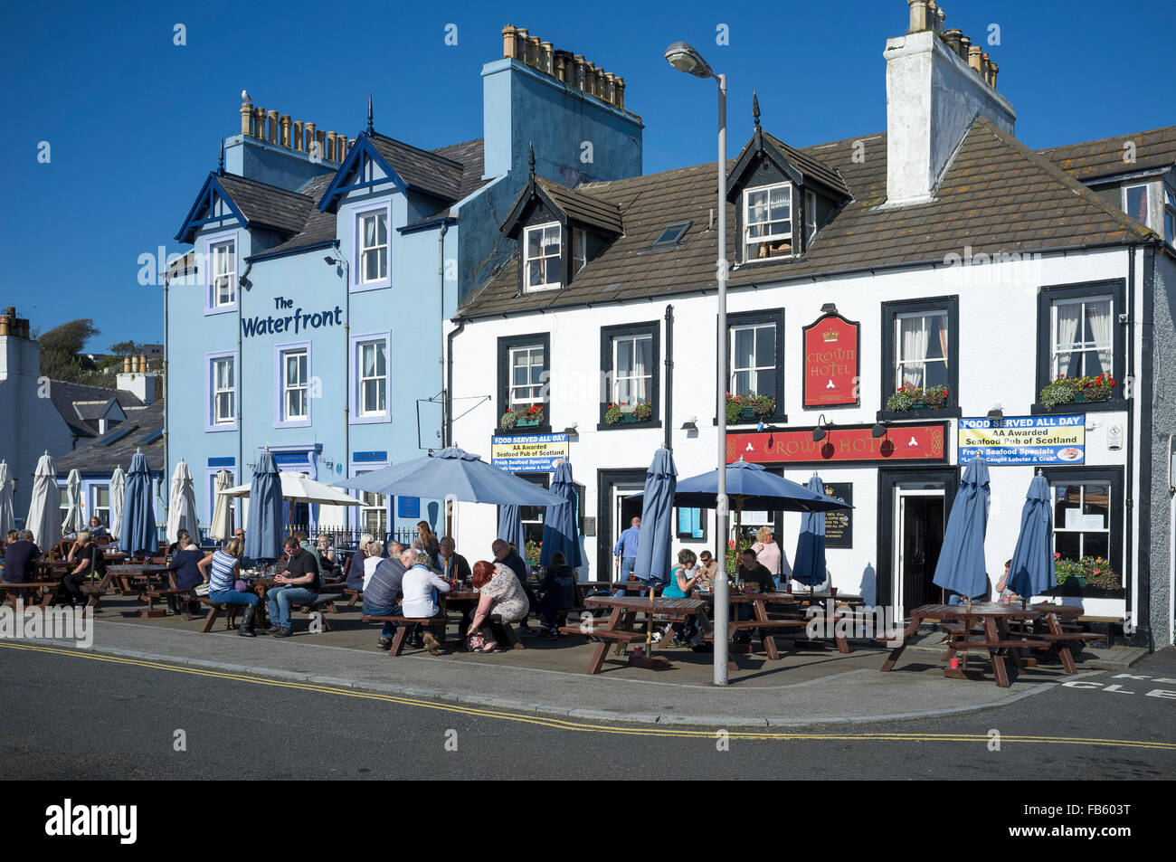 People enjoying drinks in the sunshine outside The Waterfront Hotel and ...
