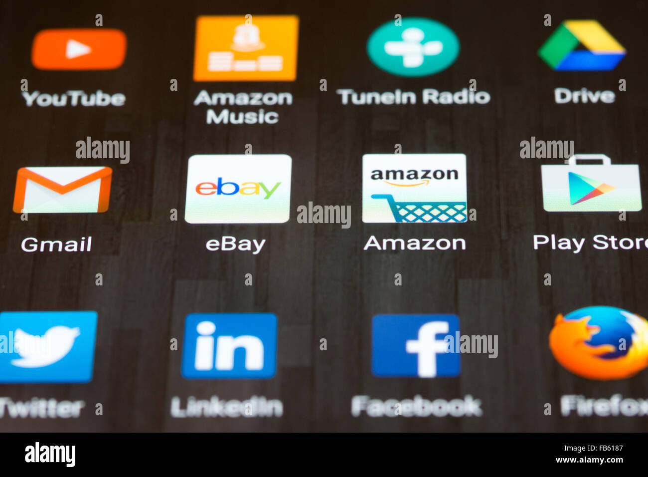 A closeup of a mobile phone smartphone screen showing some common apps ...